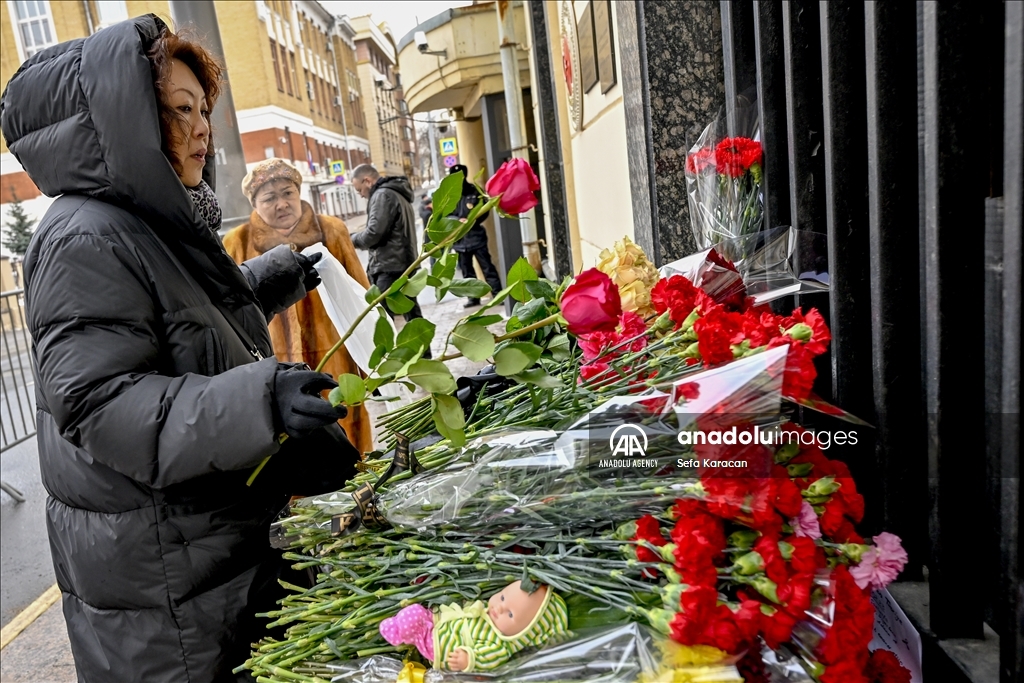 People lay flowers and pray in front of the Turkish Embassy in the ...